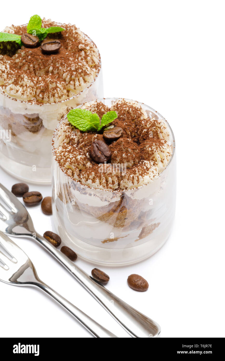 two portions Classic tiramisu dessert in a glass isolated on a white ...