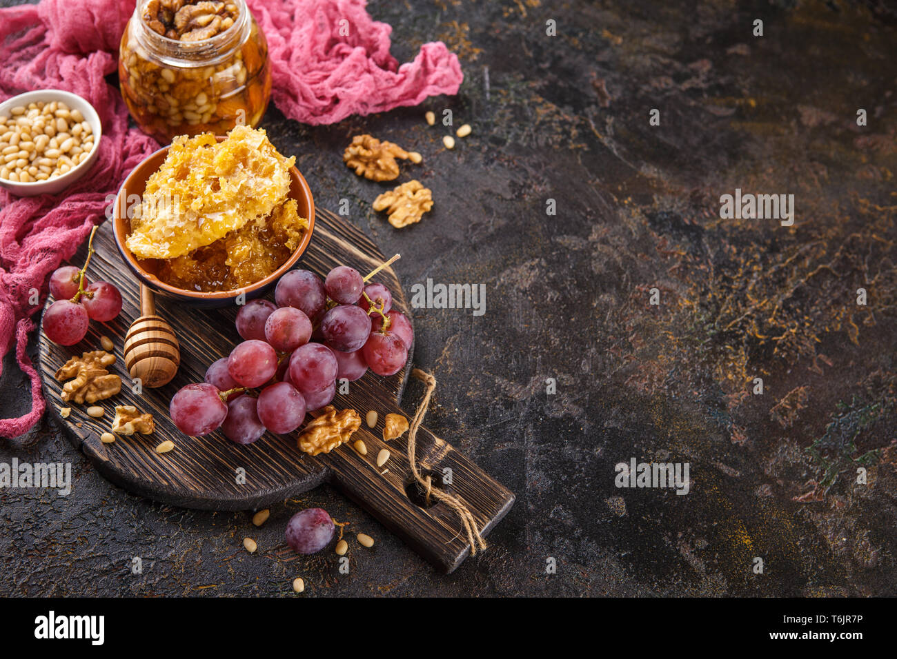 Honey, grapes and nuts Stock Photo - Alamy