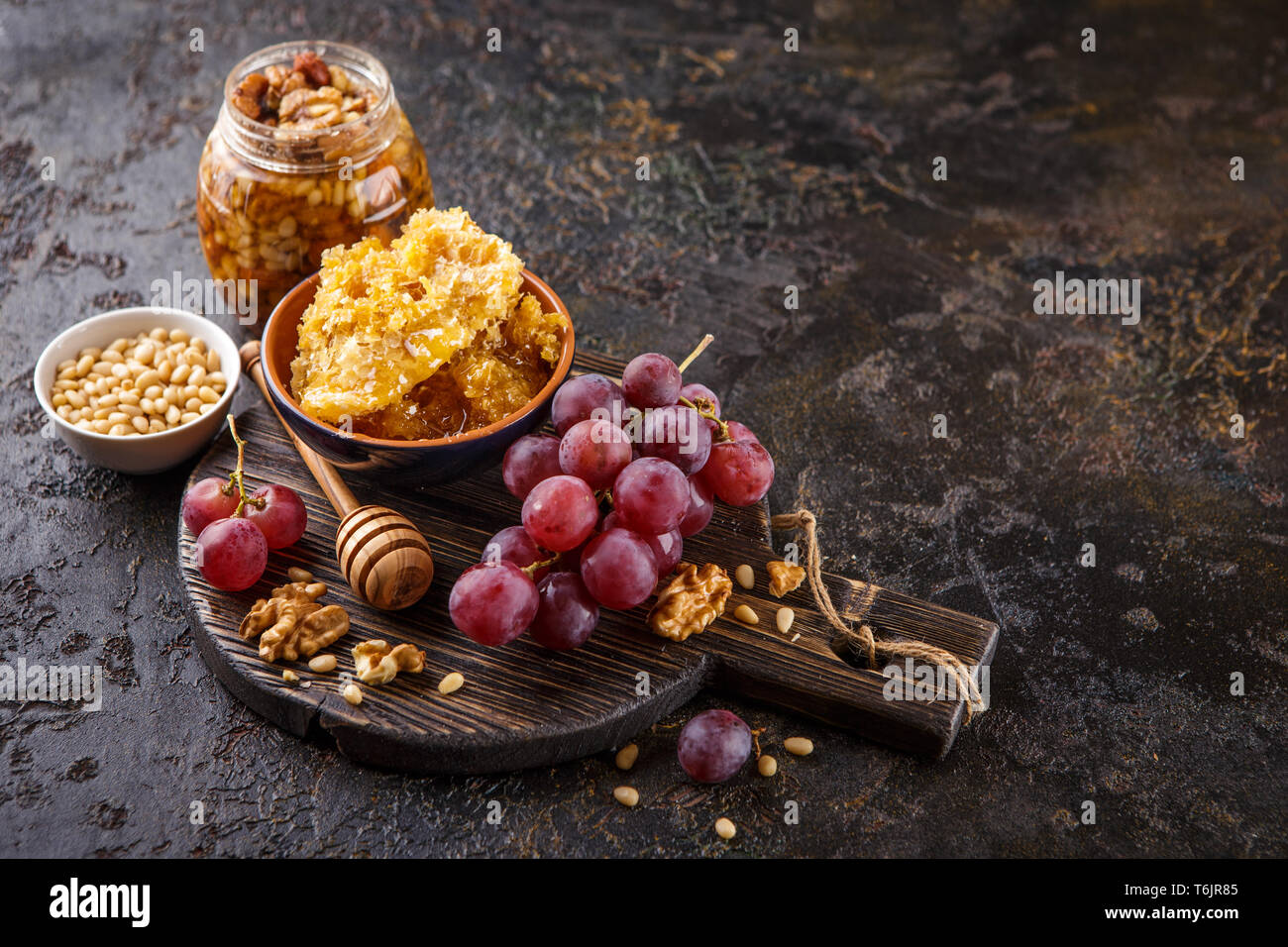 Honey, grapes and nuts Stock Photo - Alamy