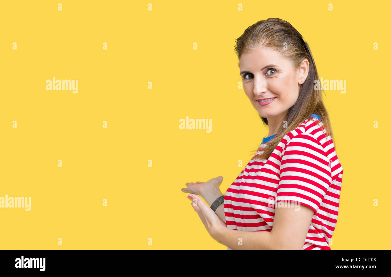 Middle age mature woman wearing casual t-shirt over isolated background ...