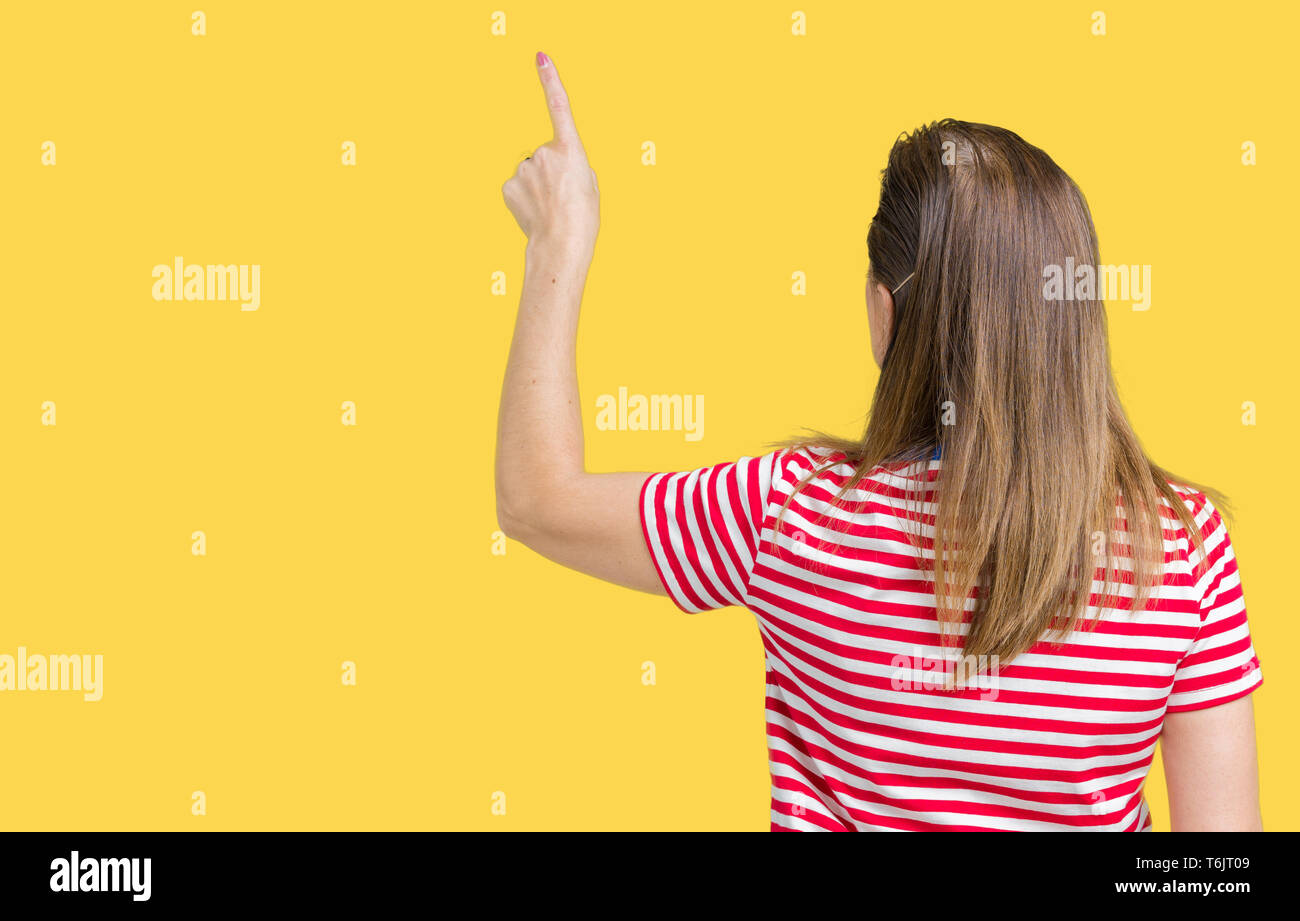 Middle age mature woman wearing casual t-shirt over isolated background ...