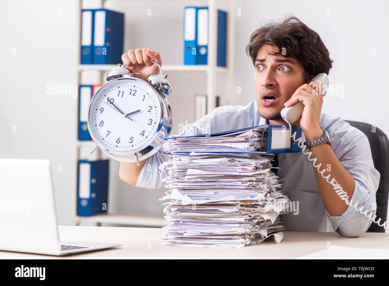 The overloaded busy employee with too much work and paperwork Stock ...