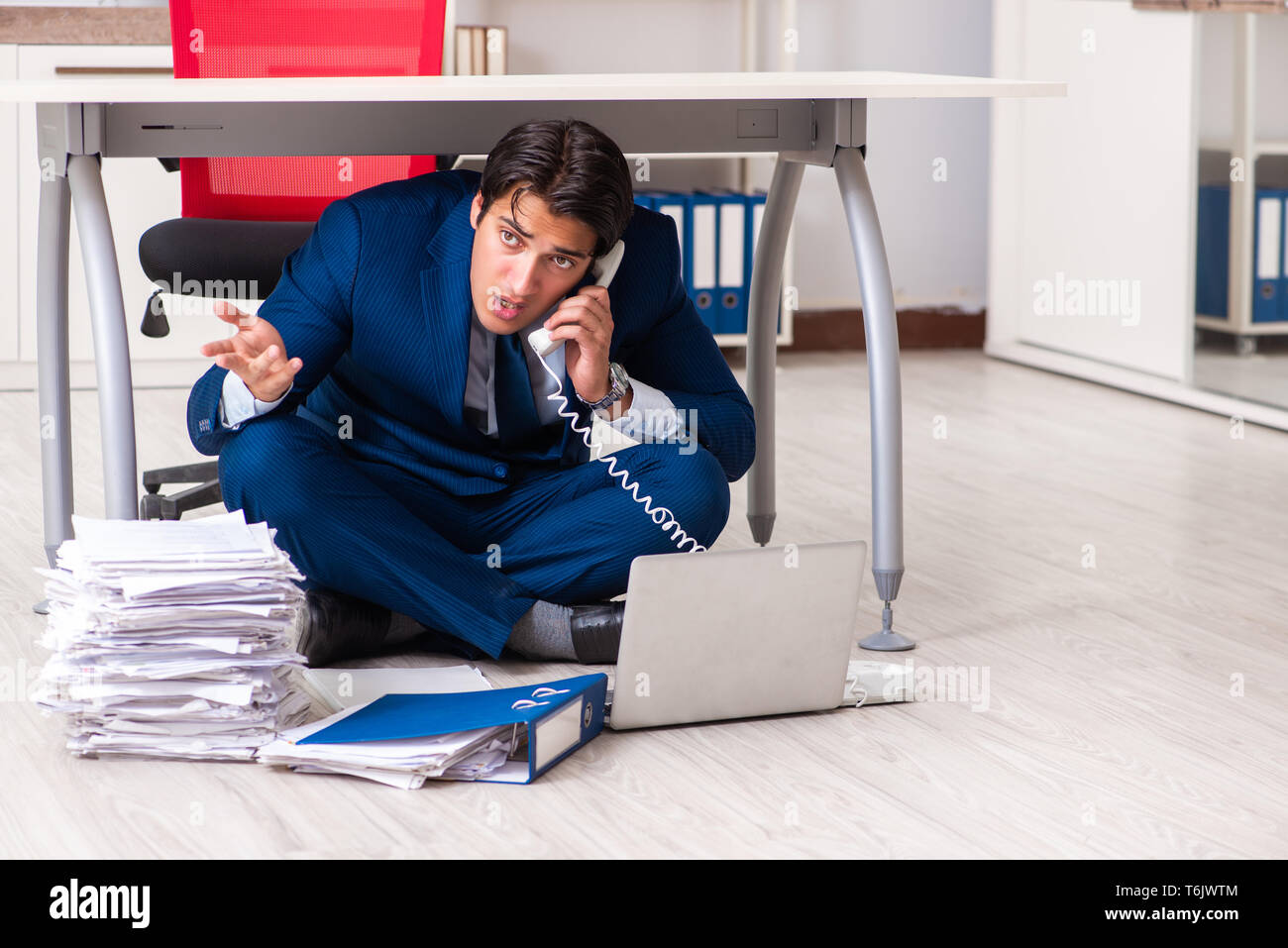 The tired exhausted businessman working overtime in office Stock Photo ...