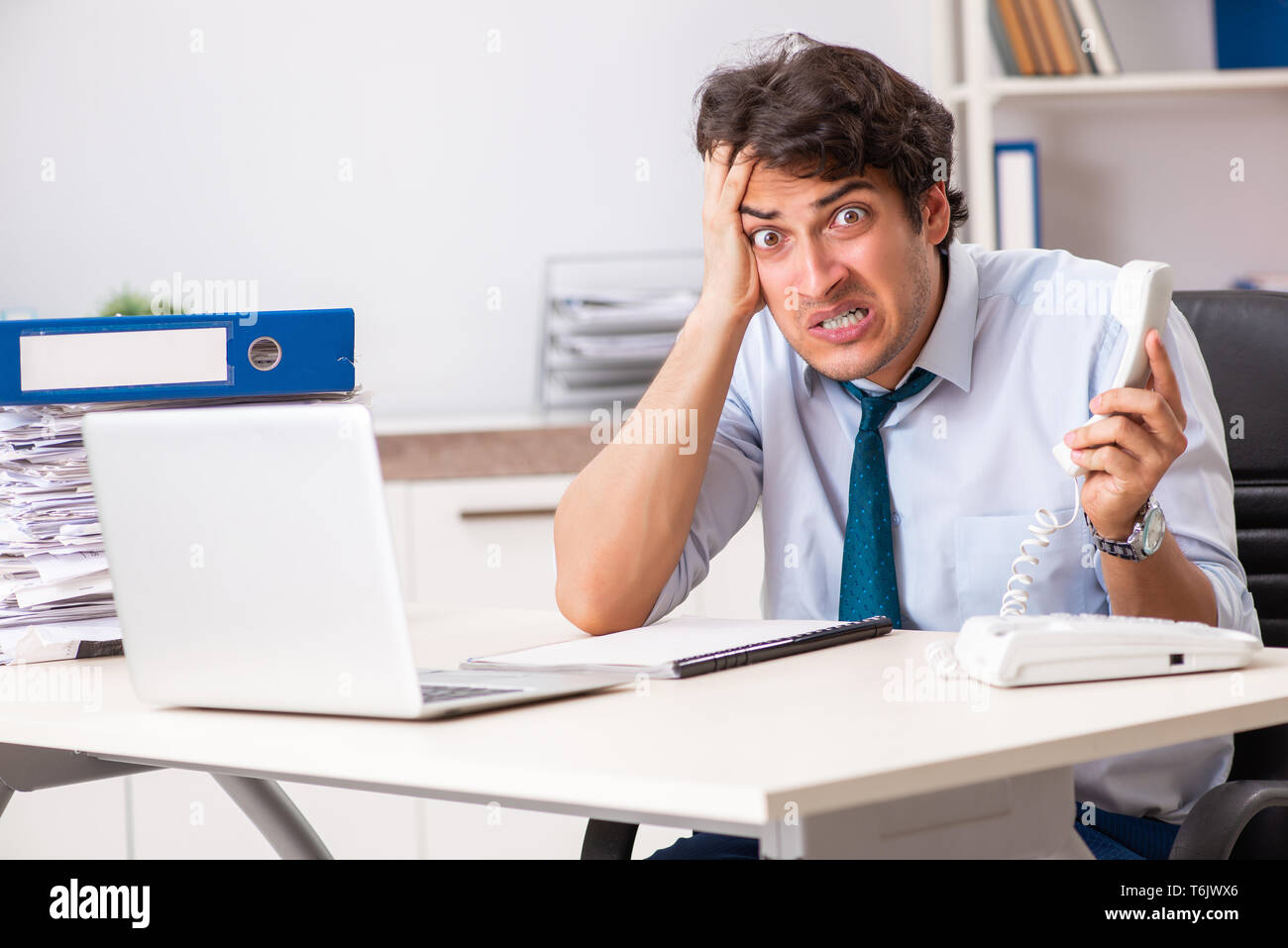 The overloaded busy employee with too much work and paperwork Stock ...