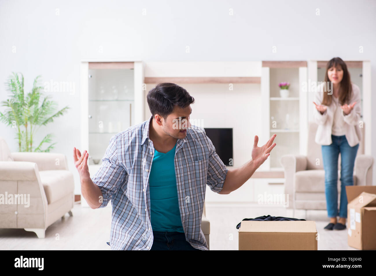 The woman evicting man from house during family conflict Stock Photo ...