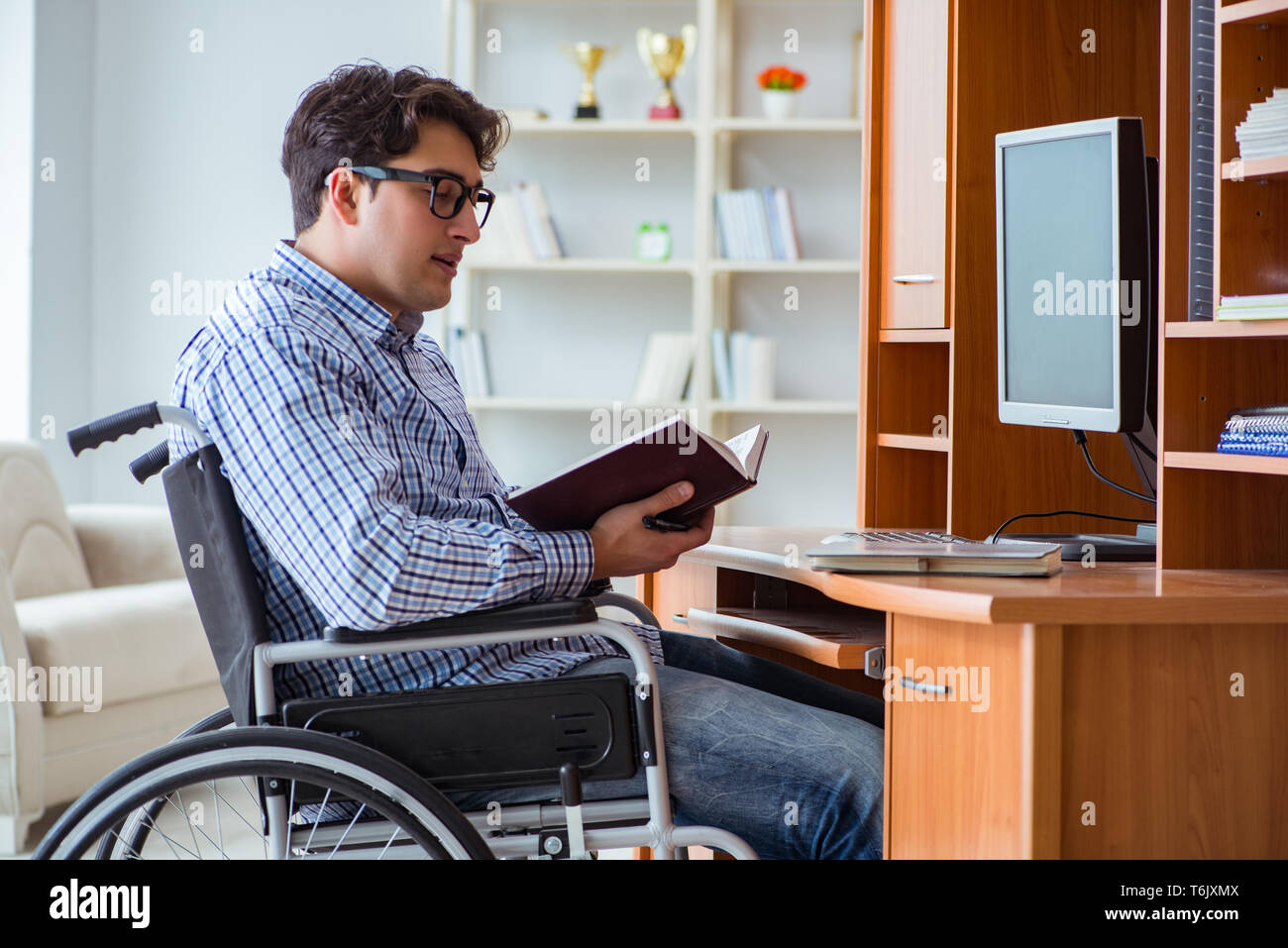 The disabled student studying at home on wheelchair Stock Photo - Alamy