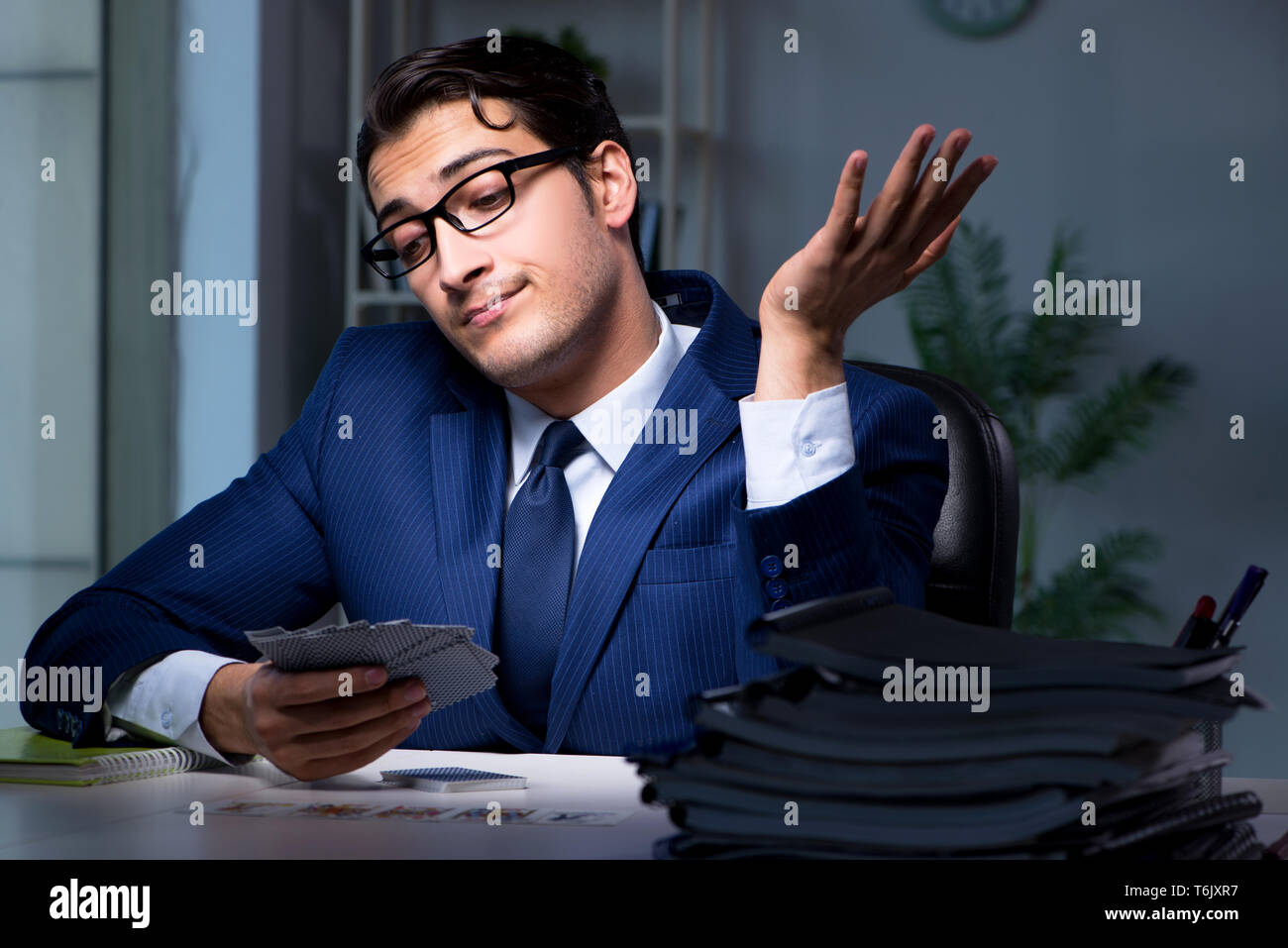 The young business playing cards late in office Stock Photo - Alamy