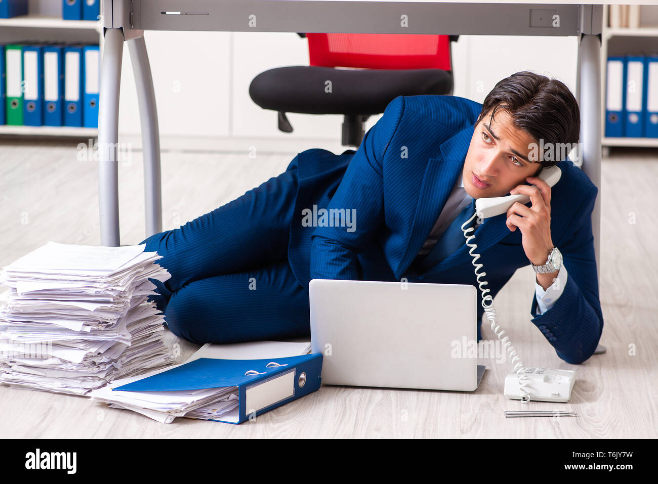 The tired exhausted businessman working overtime in office Stock Photo ...
