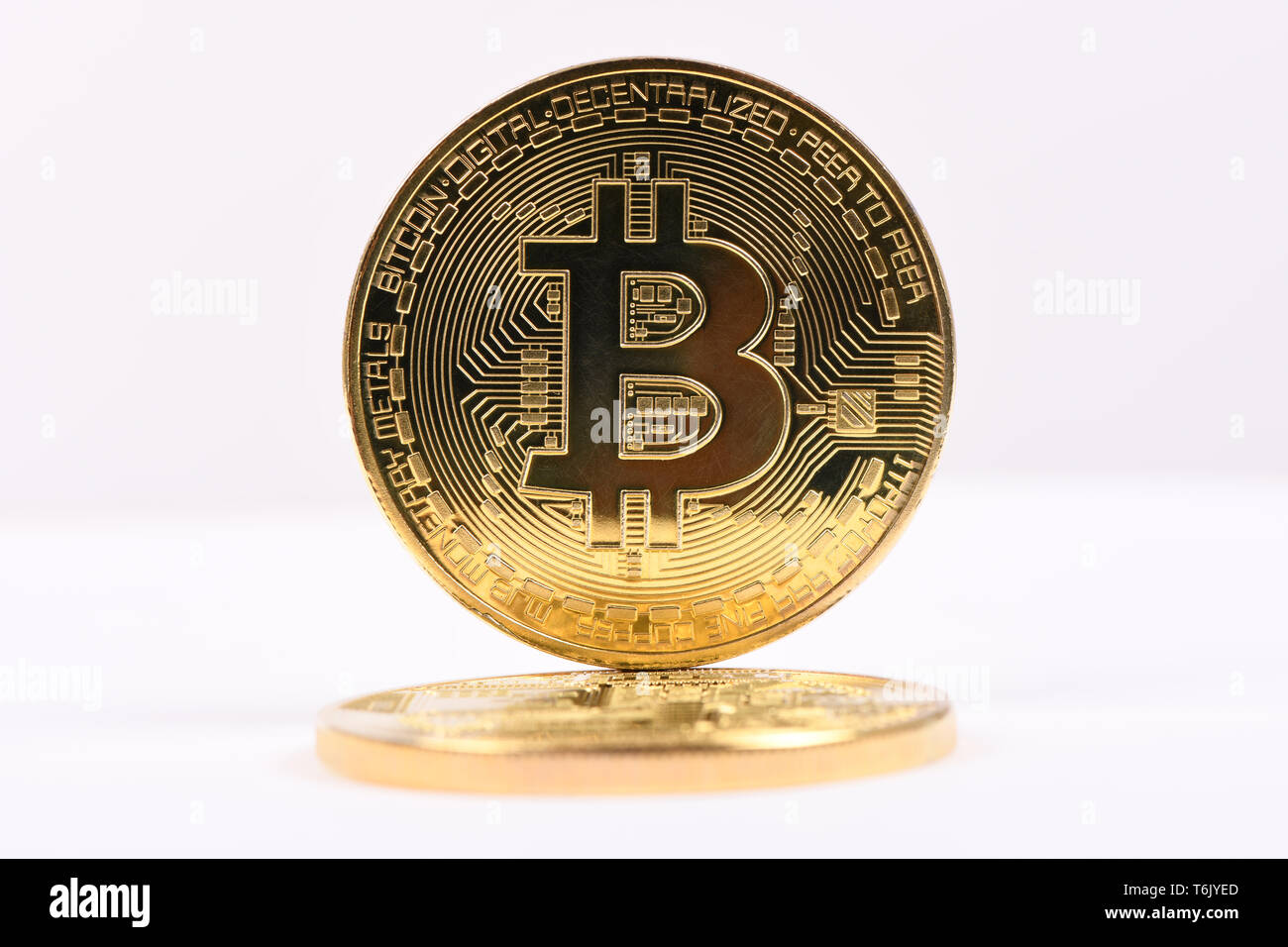 Golden bitcoin isolated on white background. Front and back sides are ...