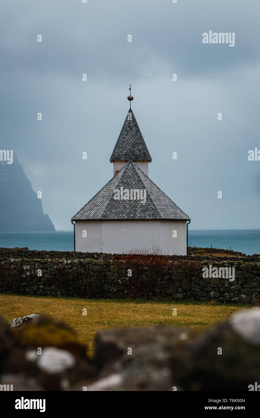 View onto the church of Viðareiði (Viðareiði Kirkja) with moody cloudy ...