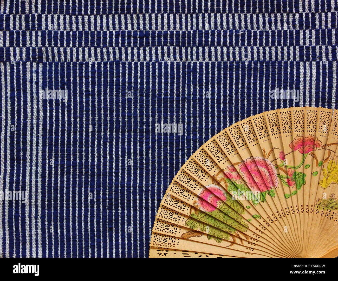 vintage Chinese wood fan on table cloth Stock Photo - Alamy