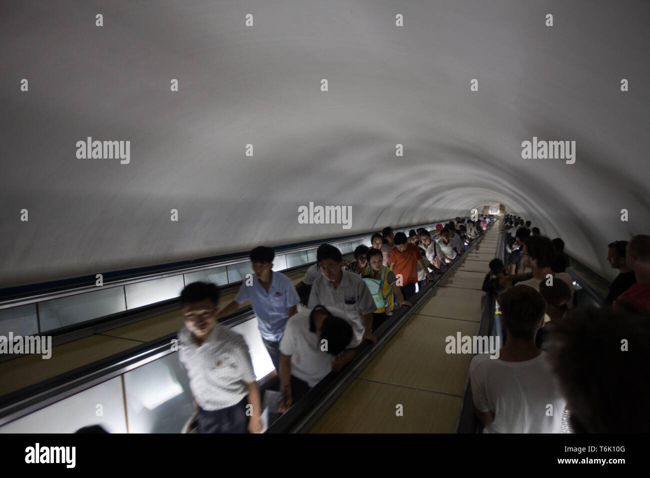 The Pyongyang metro is one of the deepest in the world. Here passengers ...