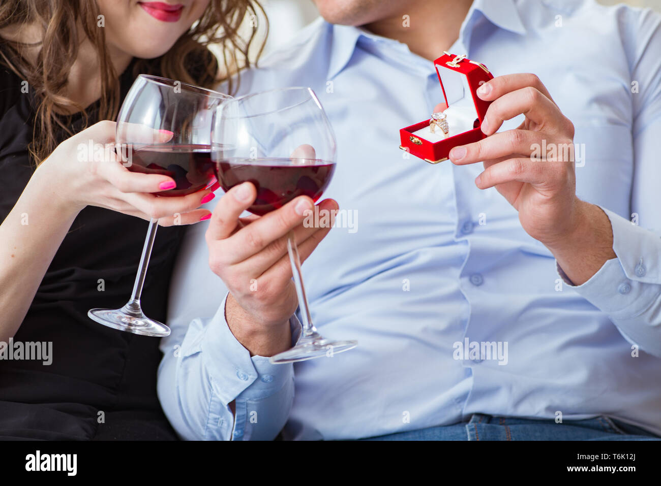 Young man making marriage proposal to girlfriend Stock Photo - Alamy