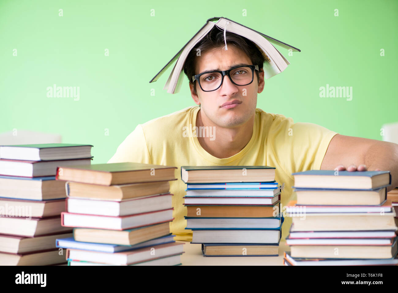 Student with too many books to read before exam Stock Photo - Alamy