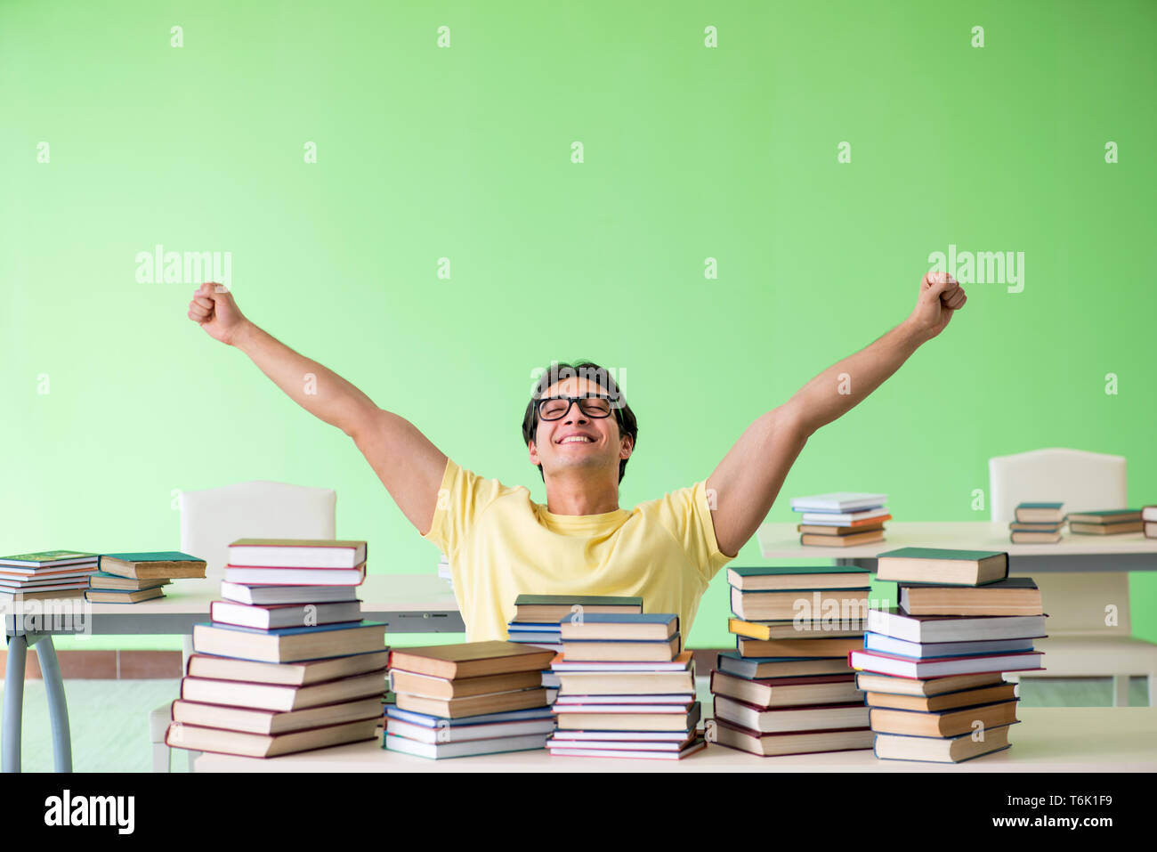 Student with too many books to read before exam Stock Photo - Alamy