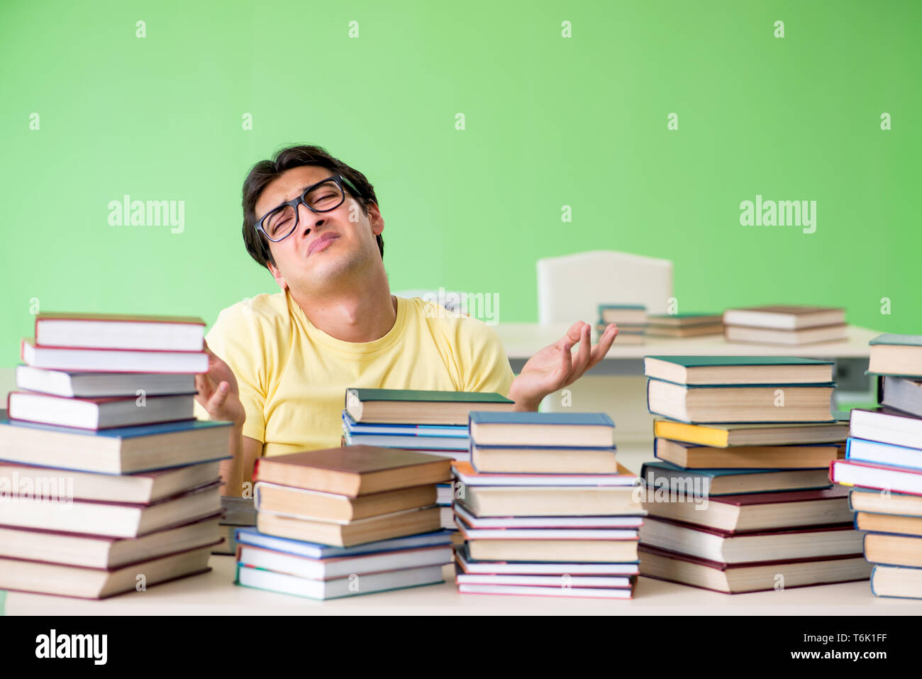 Student with too many books to read before exam Stock Photo - Alamy