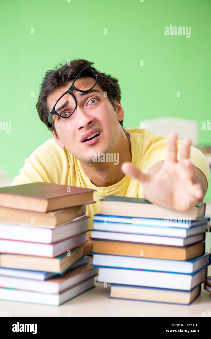 Student with too many books to read before exam Stock Photo - Alamy