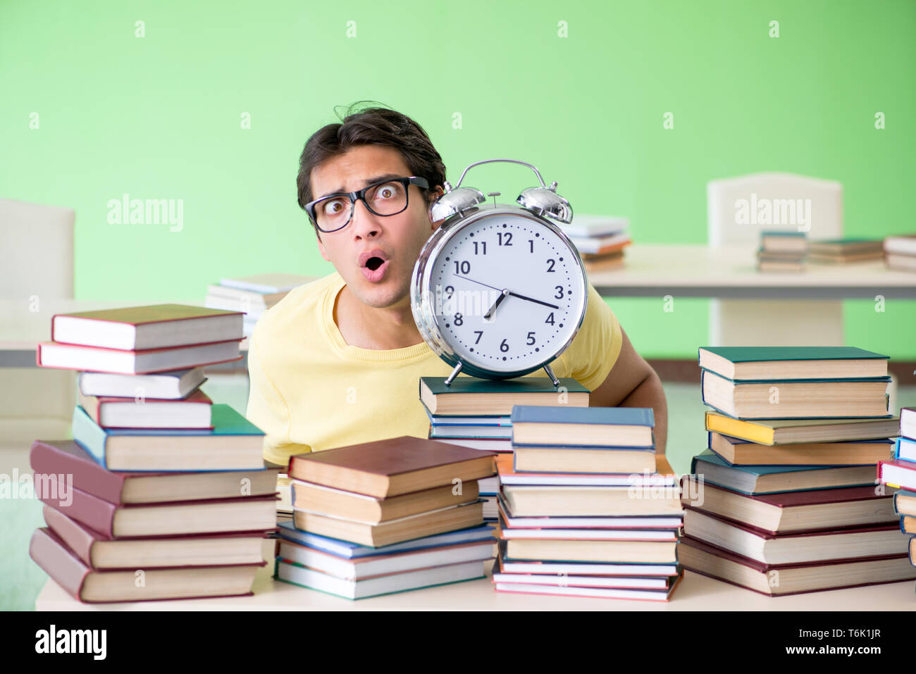Student with too many books to read before exam Stock Photo - Alamy