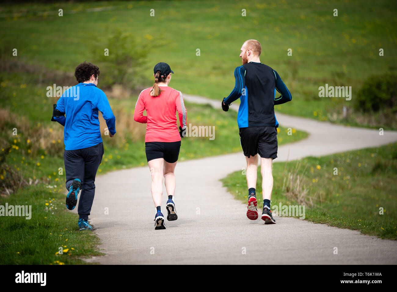 Group of people of mixed ages running together outside, preparing for ...