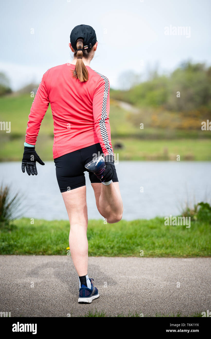 Senior woman in 50s warming up before exercising and keeping fit by ...