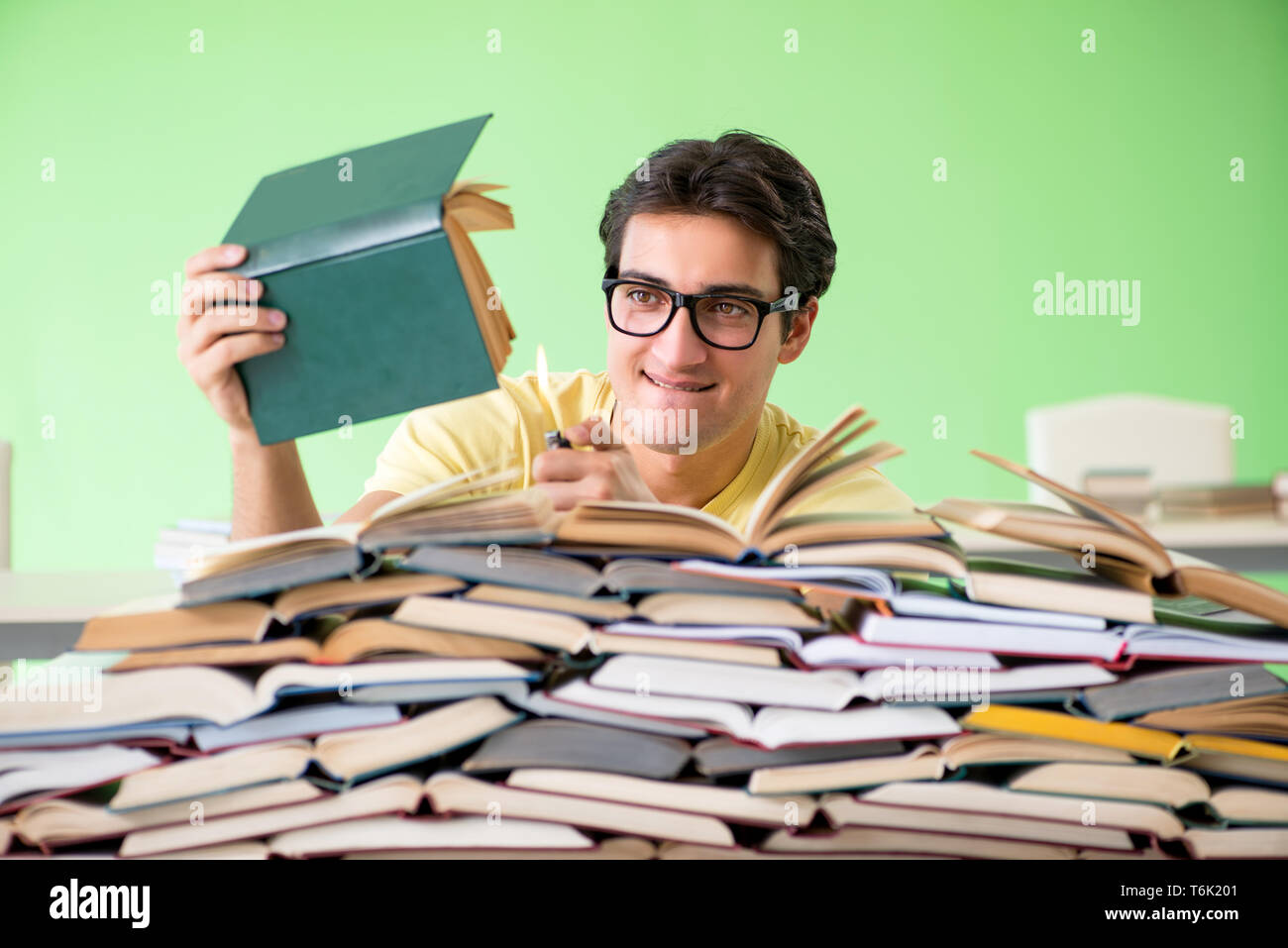 Student with too many books to read before exam Stock Photo - Alamy