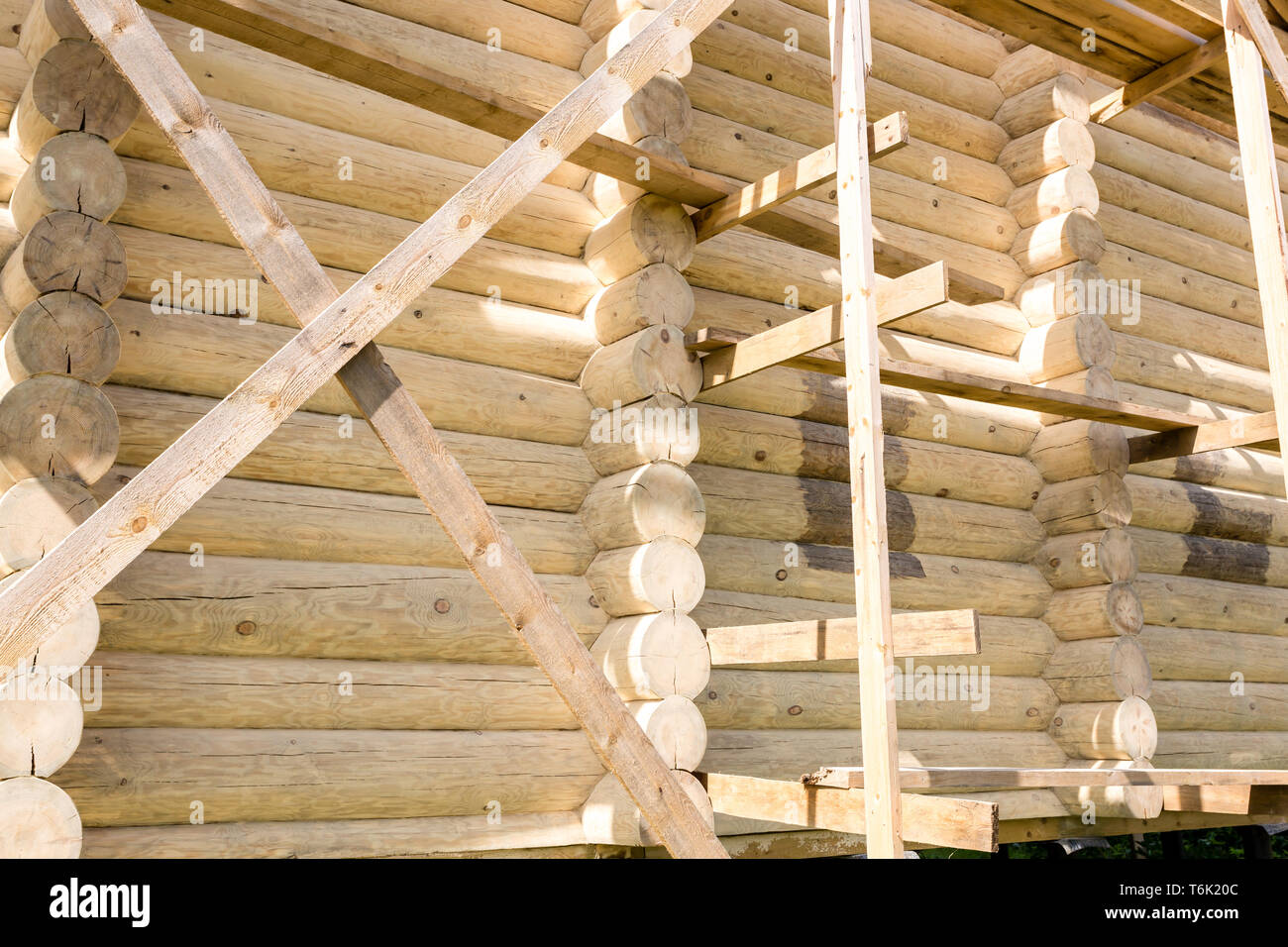 Fragment of the construction of a wooden house made of round logs ...