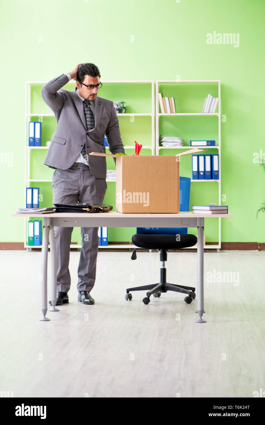 Male employee collecting his stuff after redundancy Stock Photo - Alamy