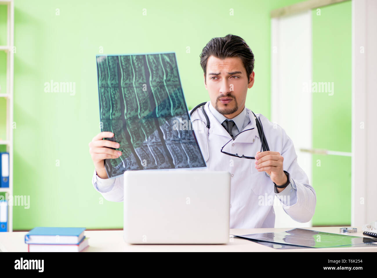 Doctor radiologist looking at x-ray scan in hospital Stock Photo - Alamy