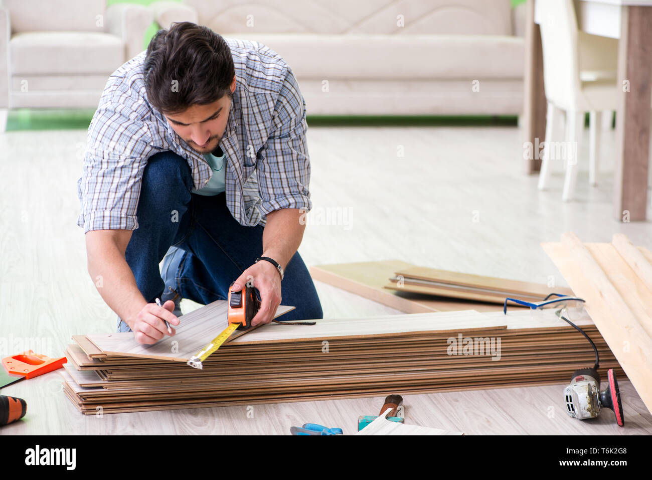 Man measuring flooring board hi-res stock photography and images - Alamy
