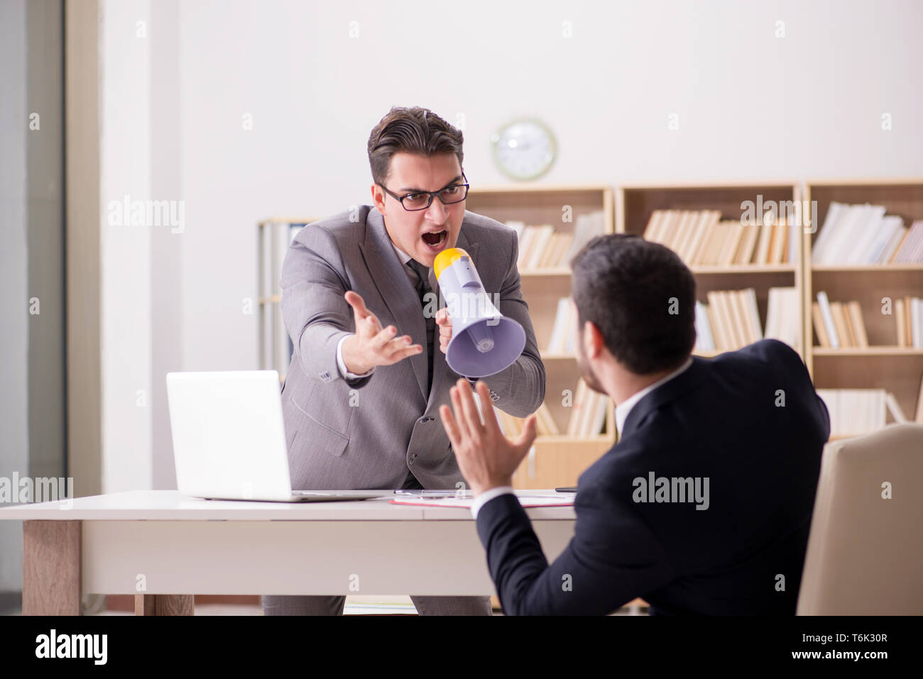 Angry boss shouting at his employee Stock Photo - Alamy
