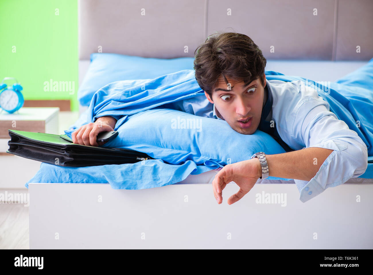 Employee in the bedroom being late for his job Stock Photo - Alamy