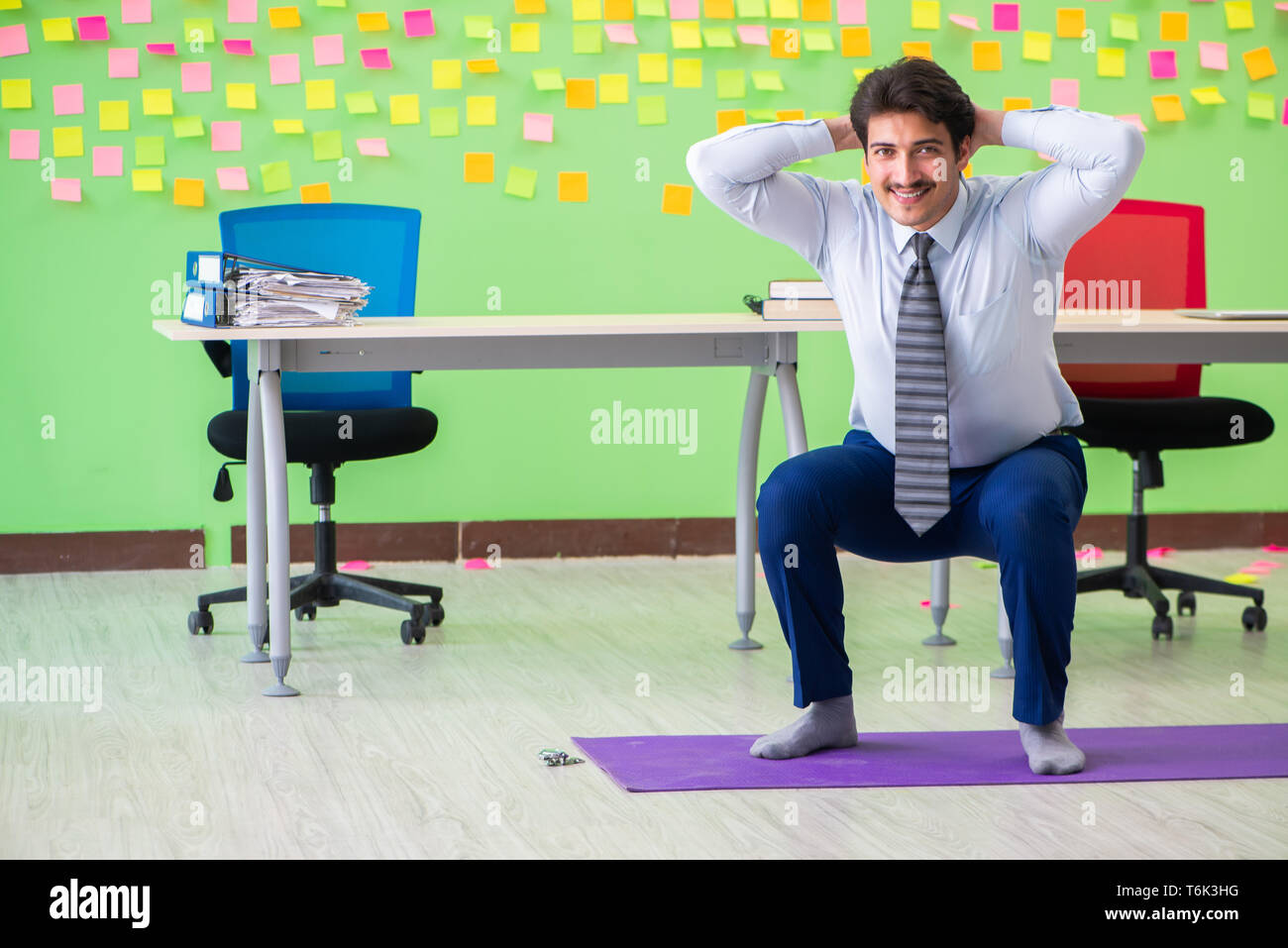Man in the office with many conflicting priorities doing exercis Stock ...