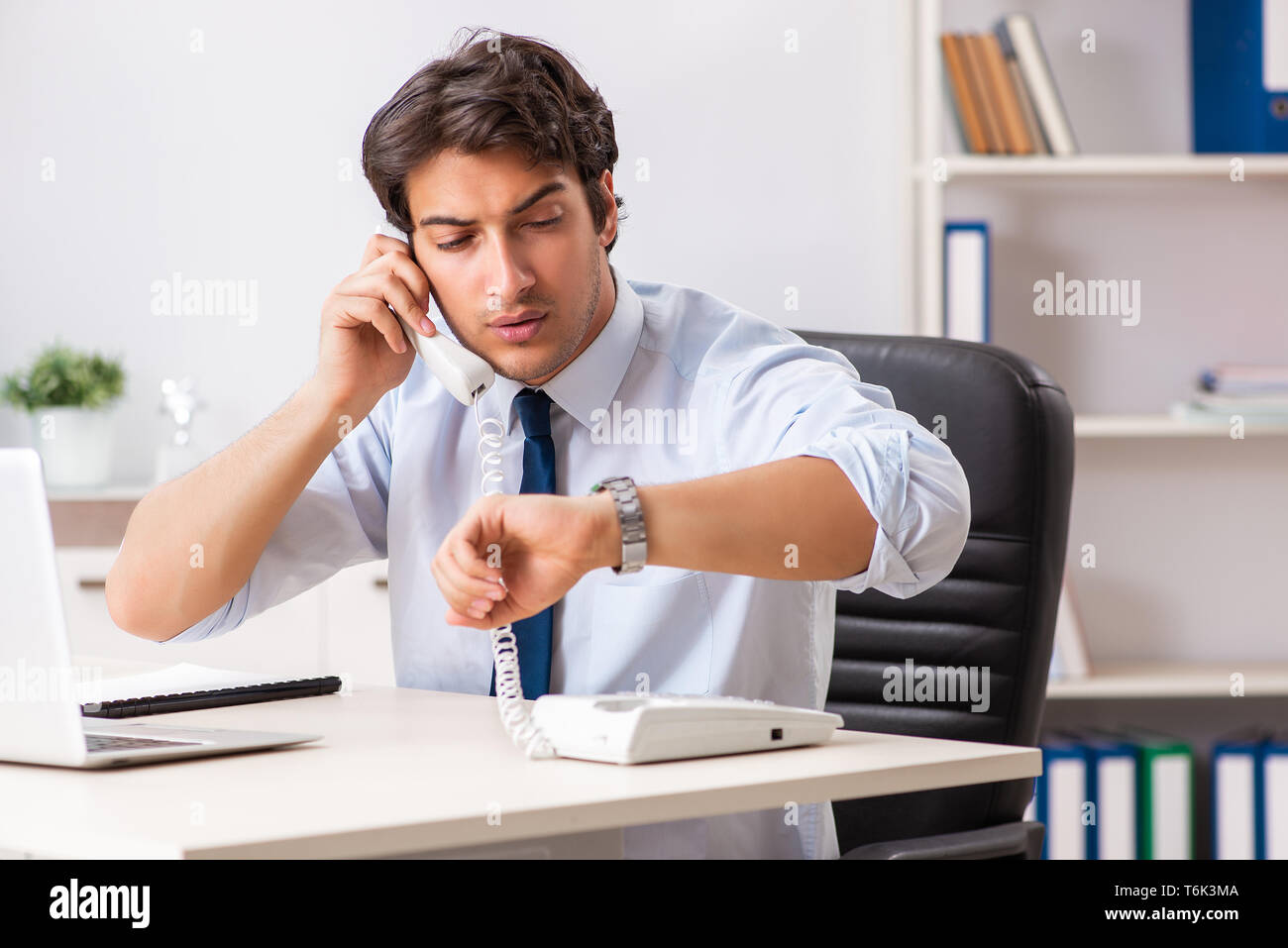 Young call center operator speaking on phone Stock Photo - Alamy