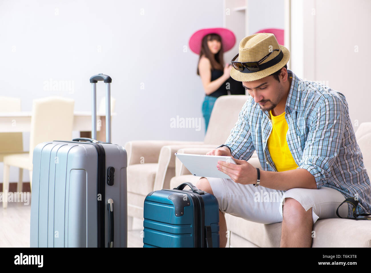Young family packing for vacation travel Stock Photo - Alamy