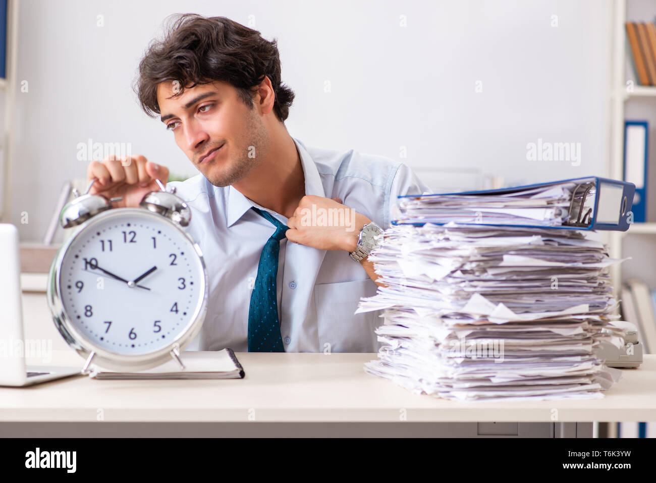 Overloaded busy employee with too much work and paperwork Stock Photo ...