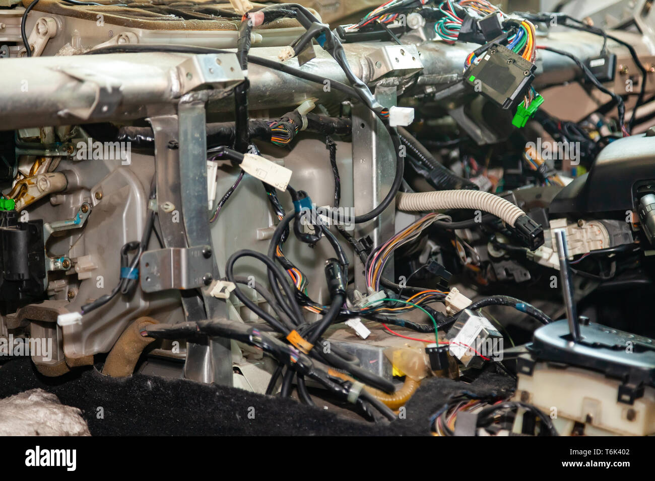 A large tangle of ravel multicolored wires from the car wiring lies in ...