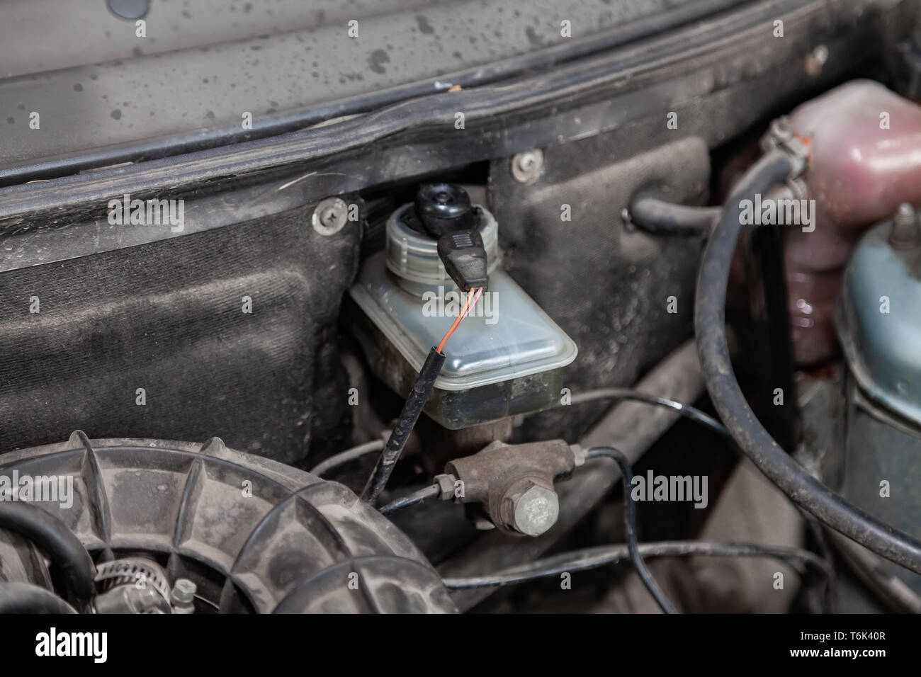 Tank brake cylinder stained with oil with a level sensor and wires ...