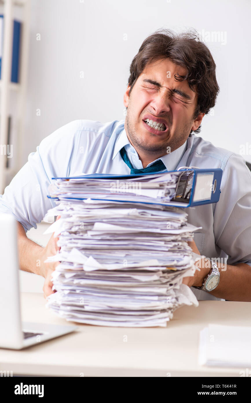 Overloaded busy employee with too much work and paperwork Stock Photo ...