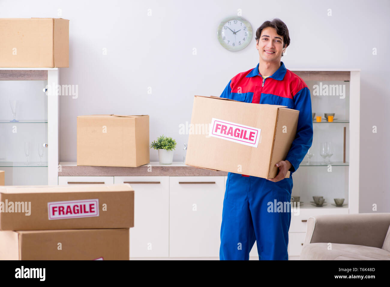Transportation contractor with fragile boxes Stock Photo - Alamy