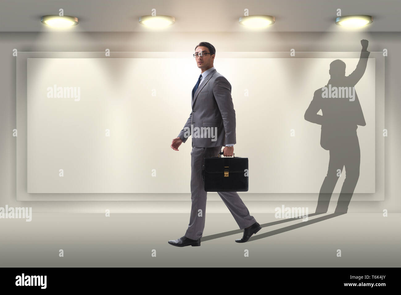 Businessman and his shadow in business concept Stock Photo - Alamy