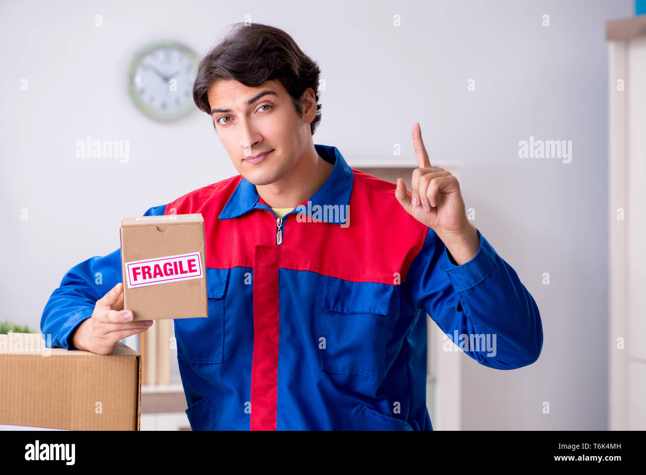 Transportation contractor with fragile boxes Stock Photo - Alamy