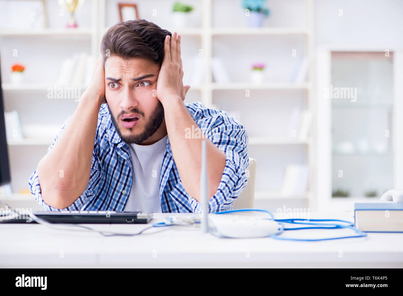 Frustrated young man due to weak internet reception Stock Photo - Alamy