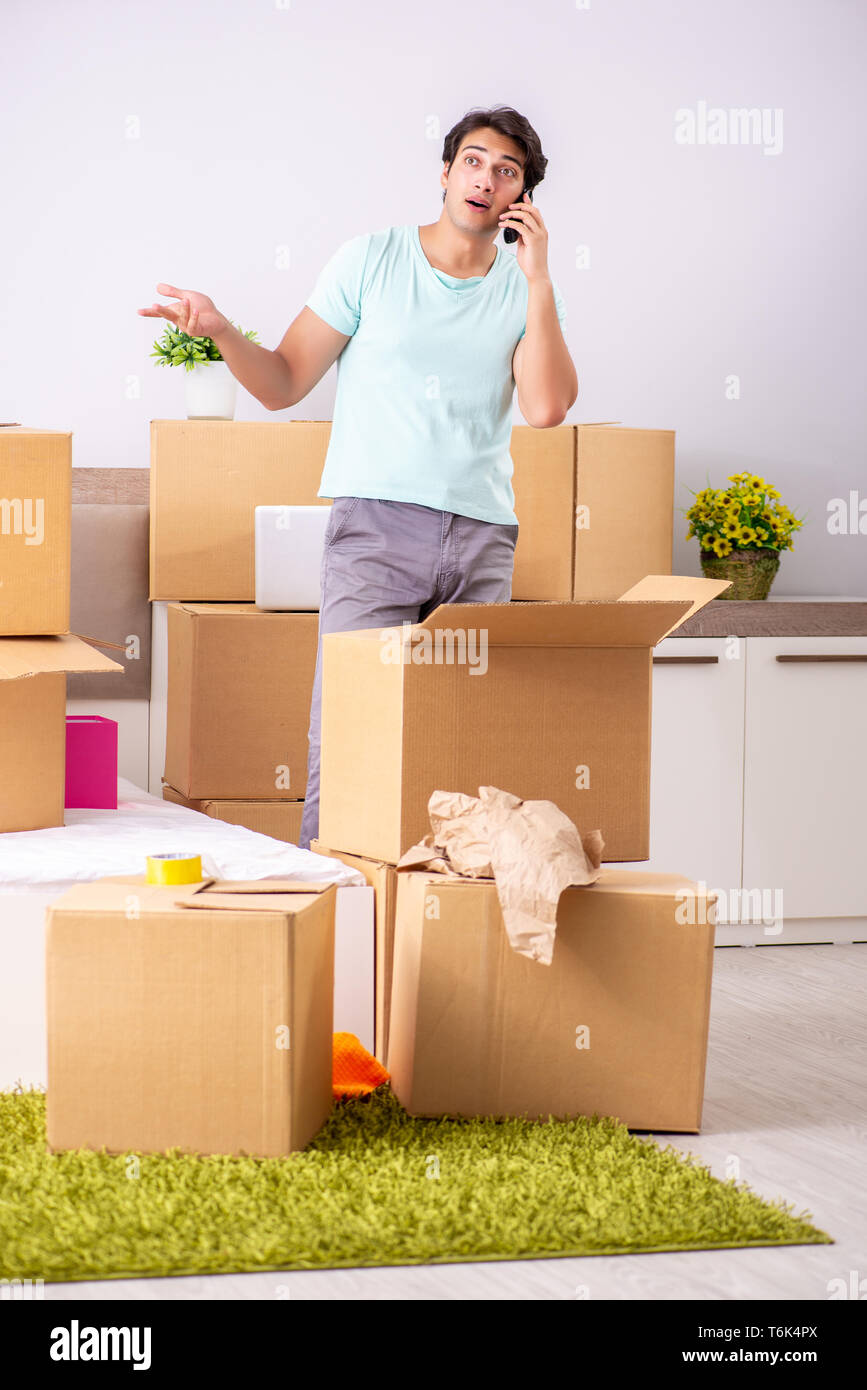 Young man moving to new apartment Stock Photo - Alamy