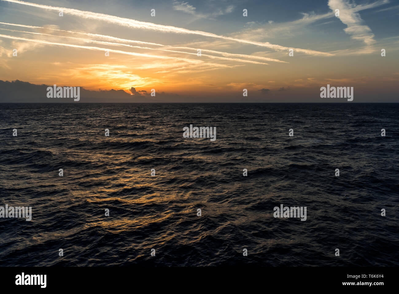 Orange sunset above sea from ship Stock Photo - Alamy