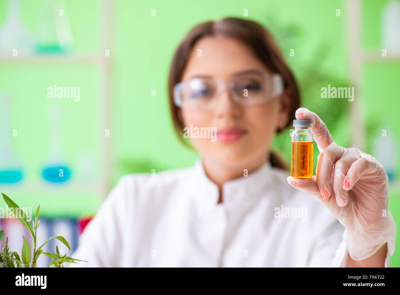 The beautiful female biotechnology scientist chemist working in lab ...