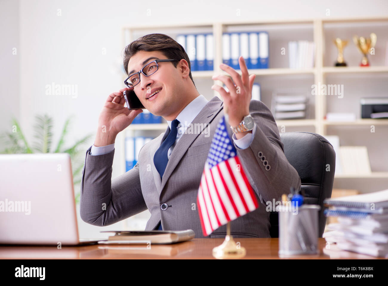 The businessman with american flag in office Stock Photo - Alamy