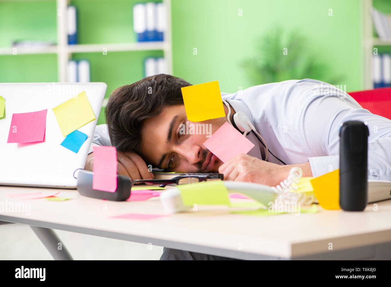 Young help desk operator working in office with many conflicting Stock ...