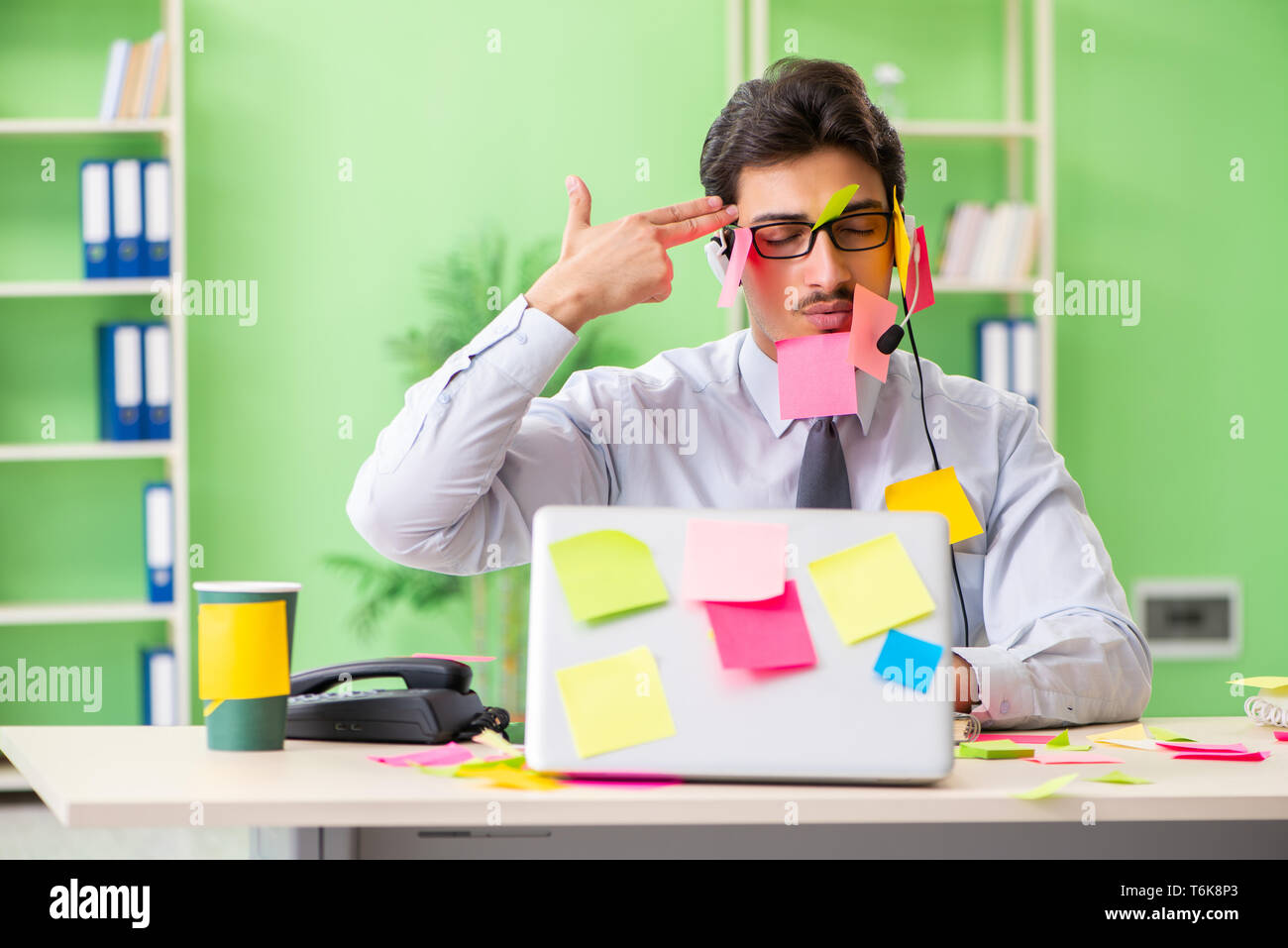 Young help desk operator working in office with many conflicting Stock ...