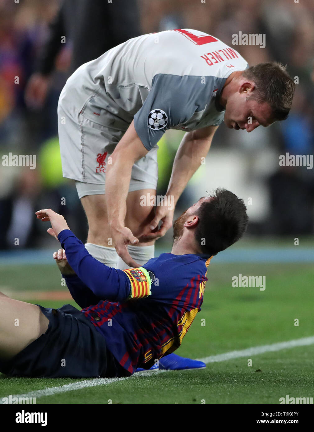 Liverpool's James Milner offers a hand after challenging Barcelona's ...