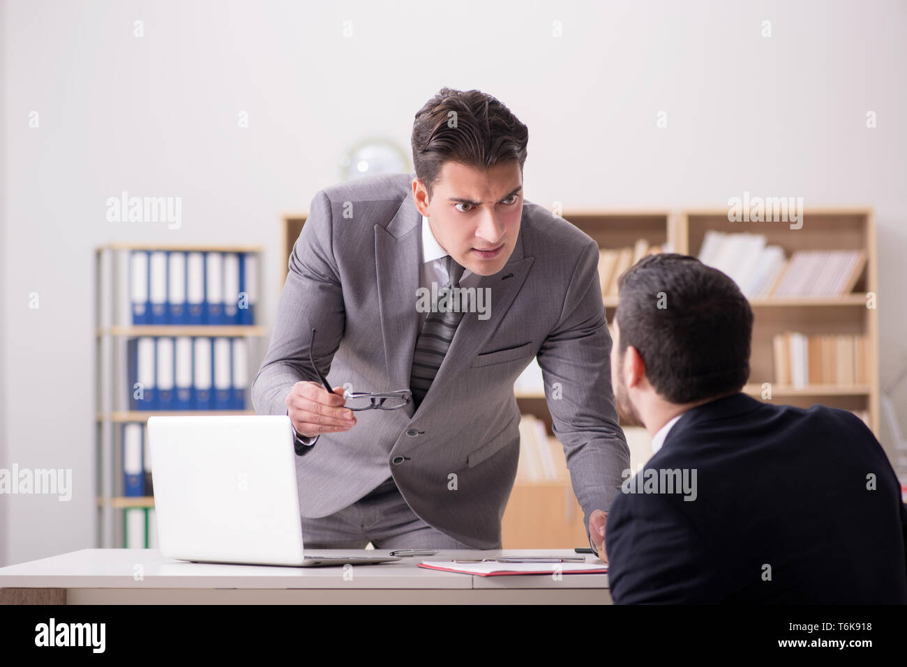 The angry boss shouting at his employee Stock Photo - Alamy
